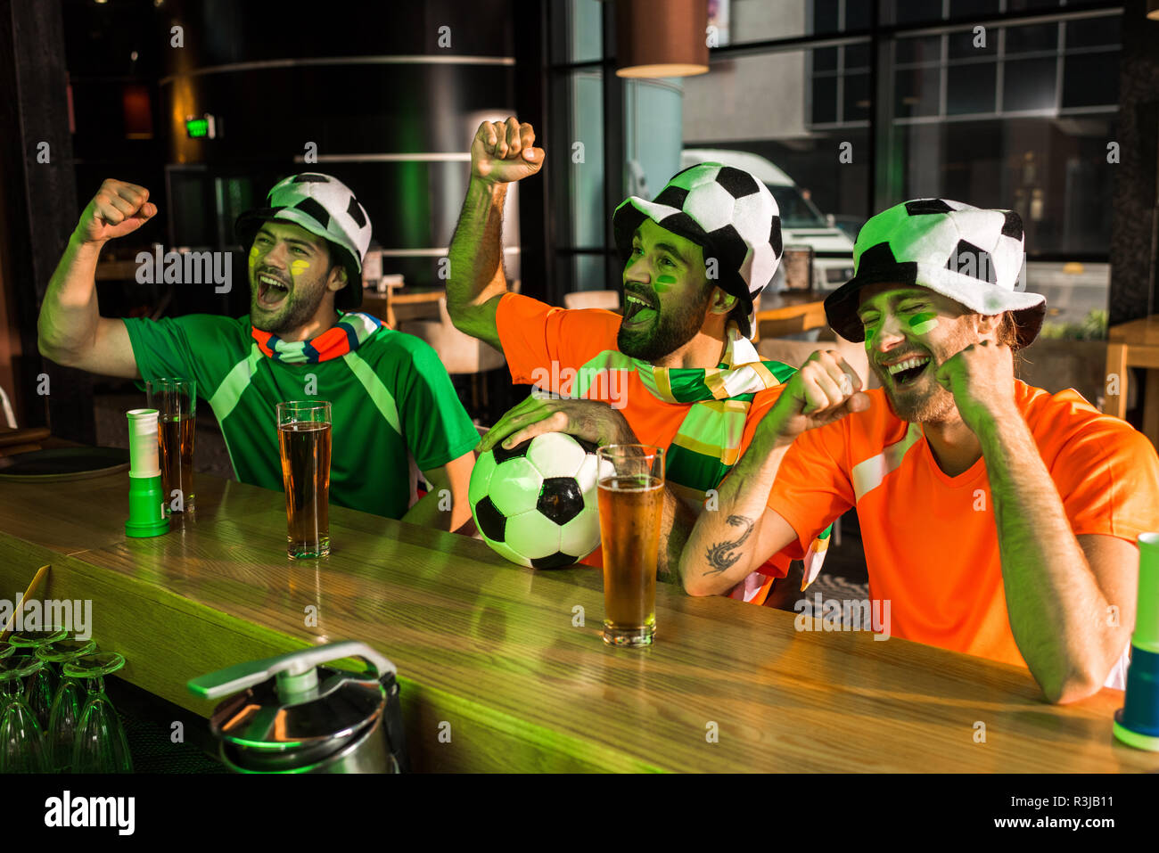 Football fans cheering and screaming in bar Stock Photo - Alamy