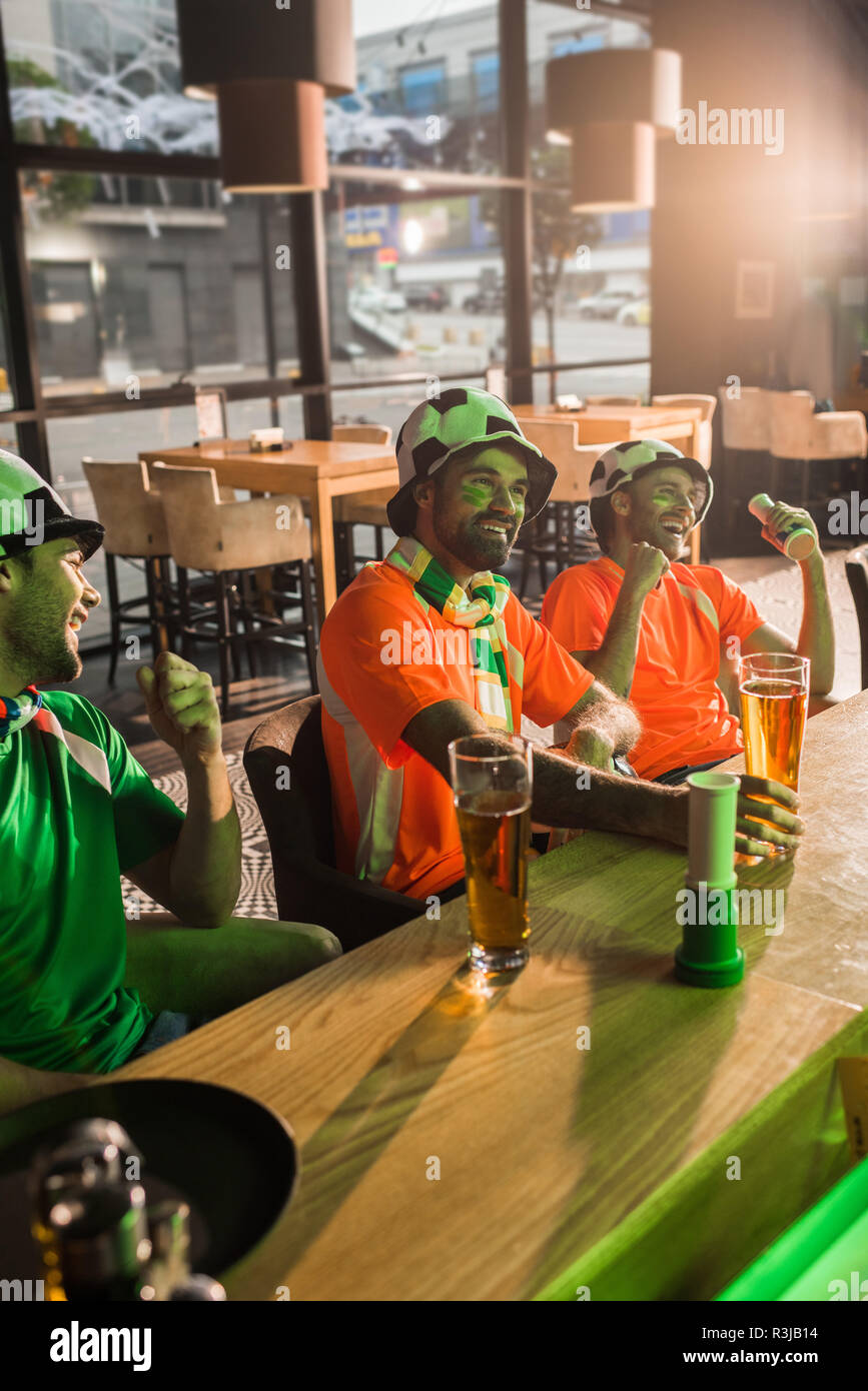 Football fans watching soccer game in bar Stock Photo - Alamy
