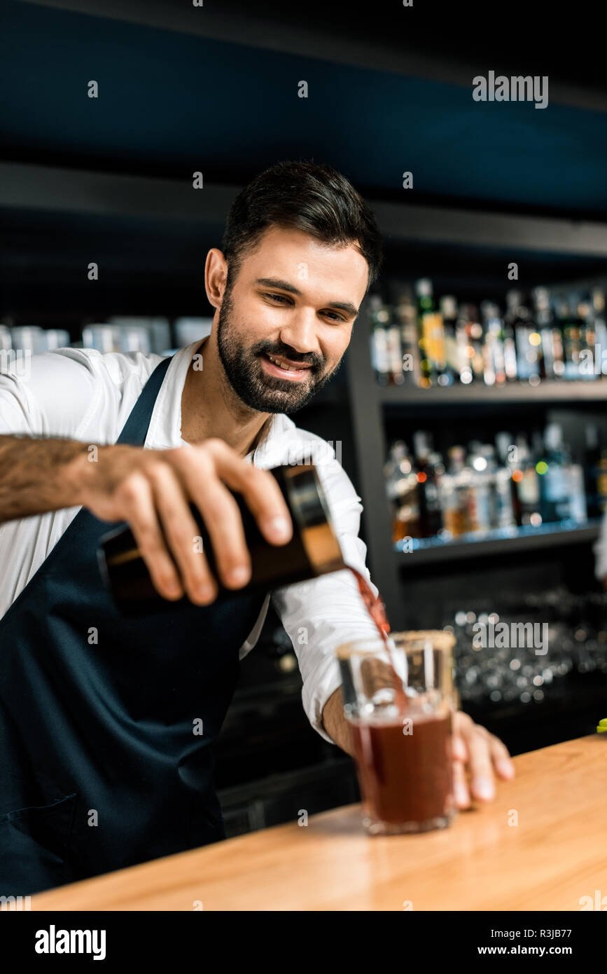 Barman pouring cocktail from shaker hi-res stock photography and images - Alamy