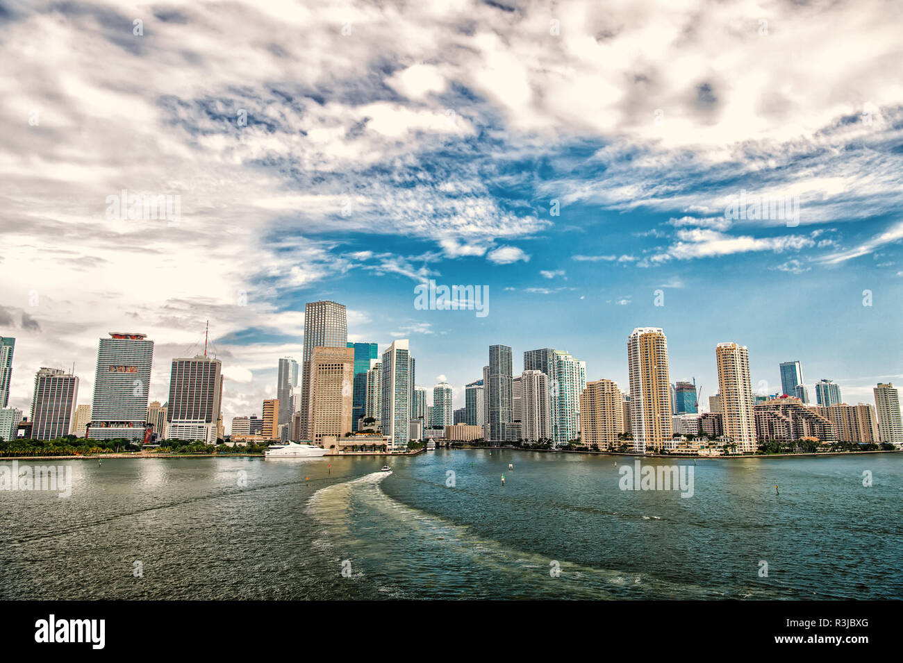 Aerial view of Miami skyscrapers with blue cloudy sky,white boat ...