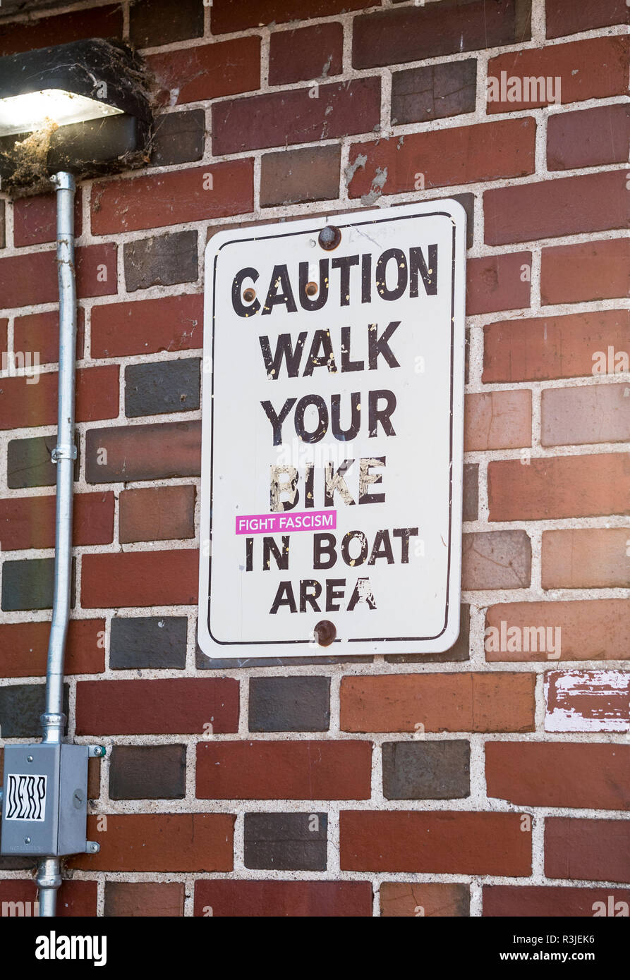 MADISON, WISCONSIN - MAY 07, 2018: A worn out caution sign on a brick ...