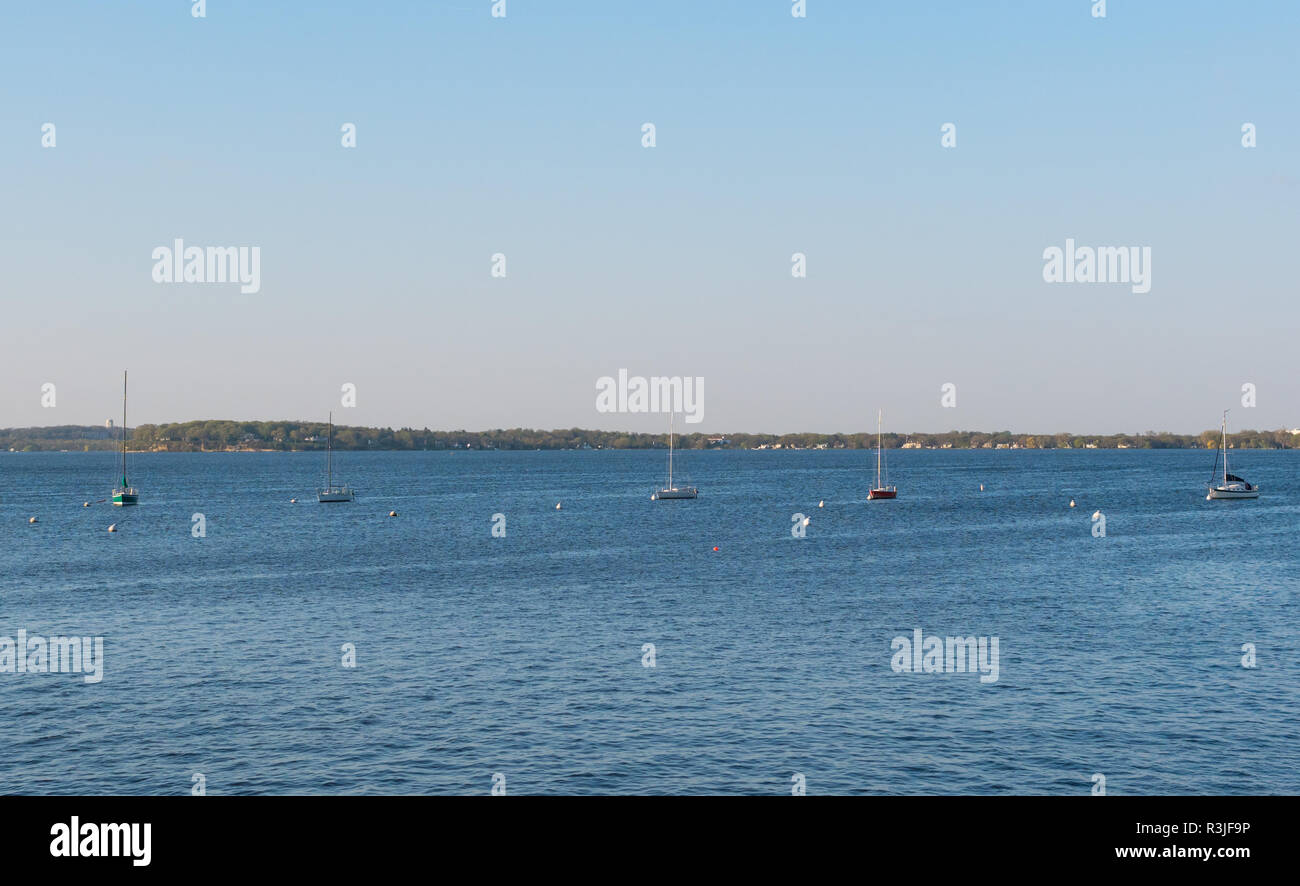 MADISON, WISCONSIN - MAY 07, 2018: Sailboats anchored in a line on Lake ...