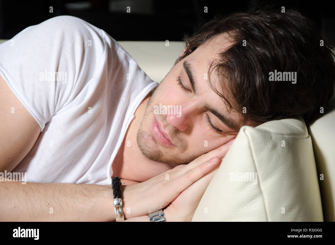 young man sleeping on couch Stock Photo - Alamy