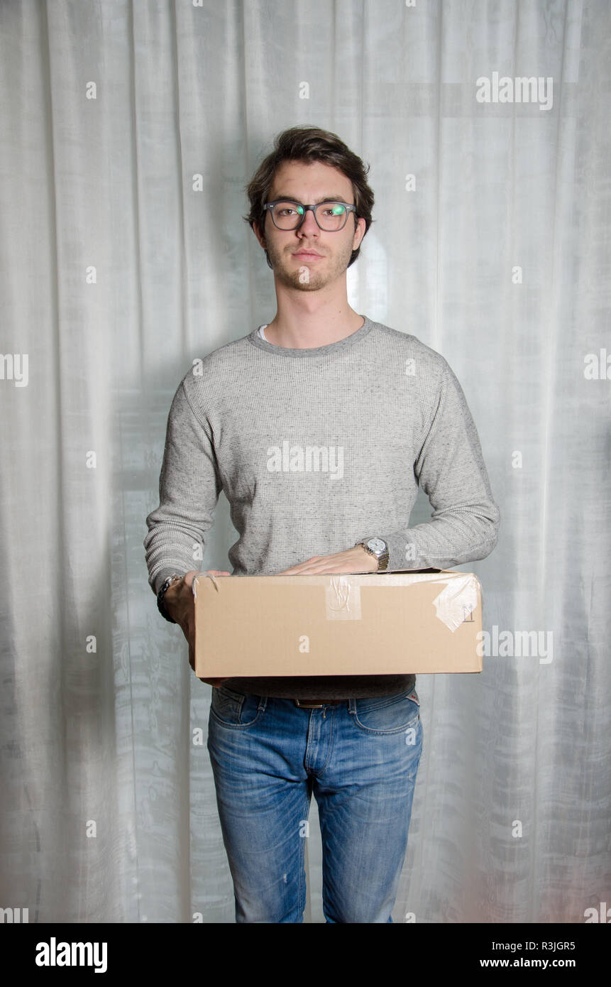 young man delivering package Stock Photo - Alamy