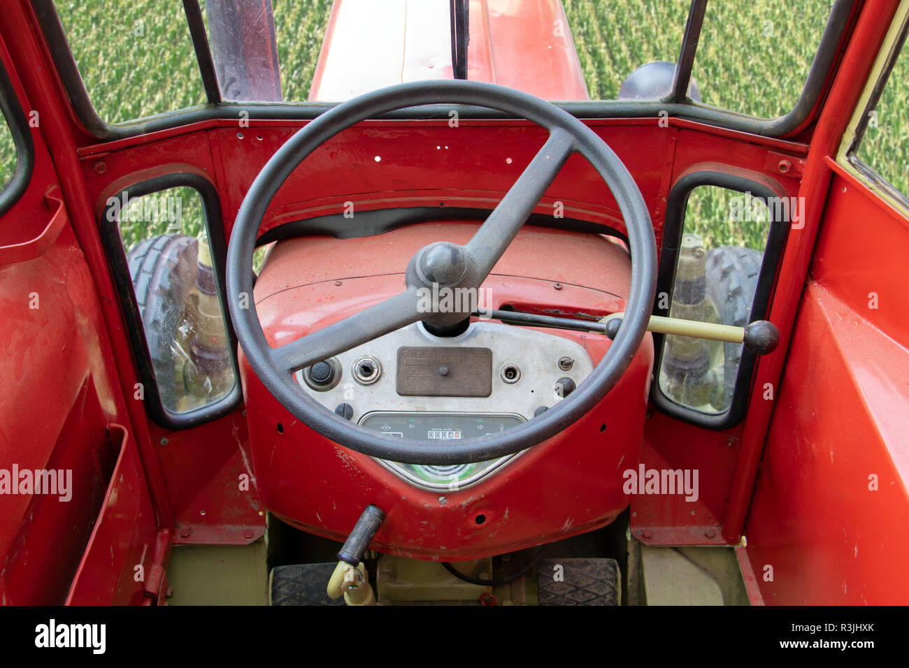 The tractor rides in the field, looking from the inside. The interior ...