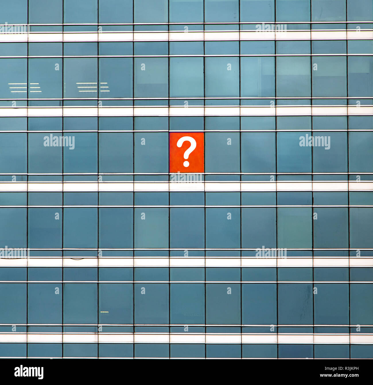 The symbol of the query mark on the building's window. The glass facade ...