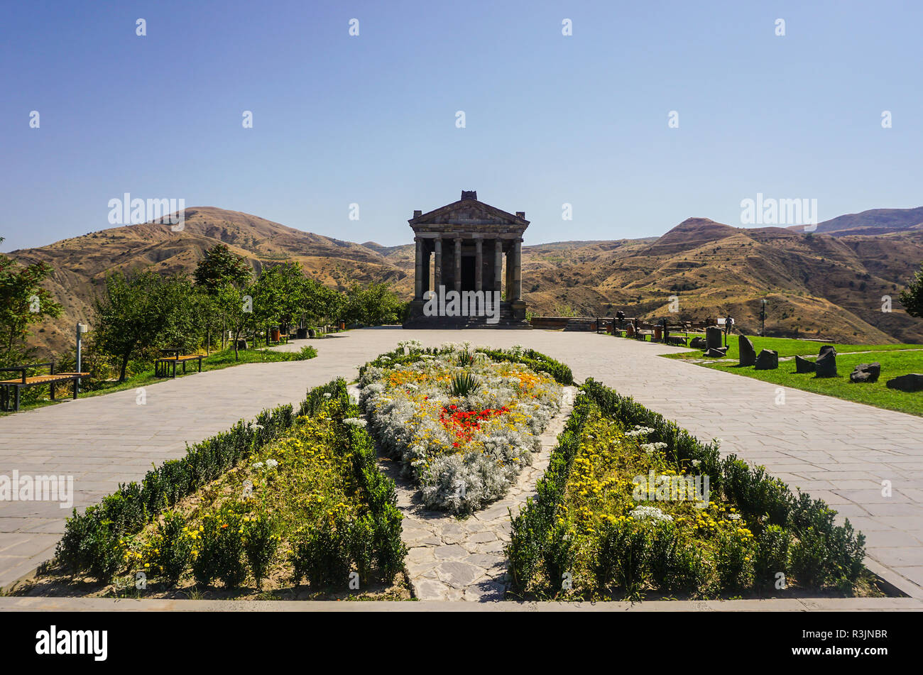 Garni Temple Main View with Garden Flowers Benches and Rocks Stock ...