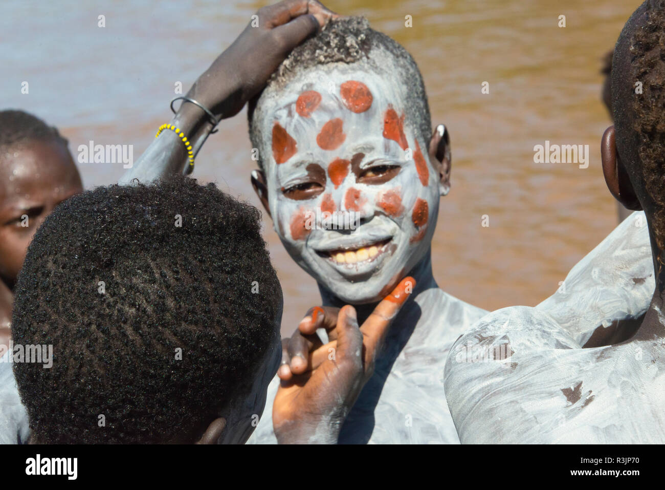 Kara tribe, boys painting each other's face, east bank of Lower Omo ...