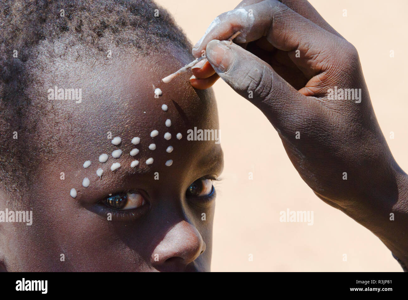 Painting Kara tribe, boy's face, east bank of Lower Omo River, Turmi ...