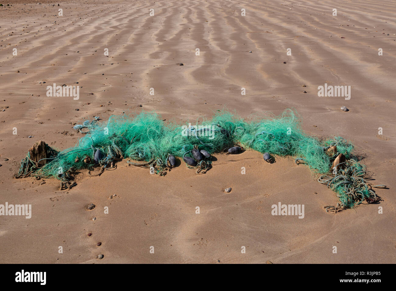 Discarded tangled fishing net on Youghal beach, County Cork, Ireland ...
