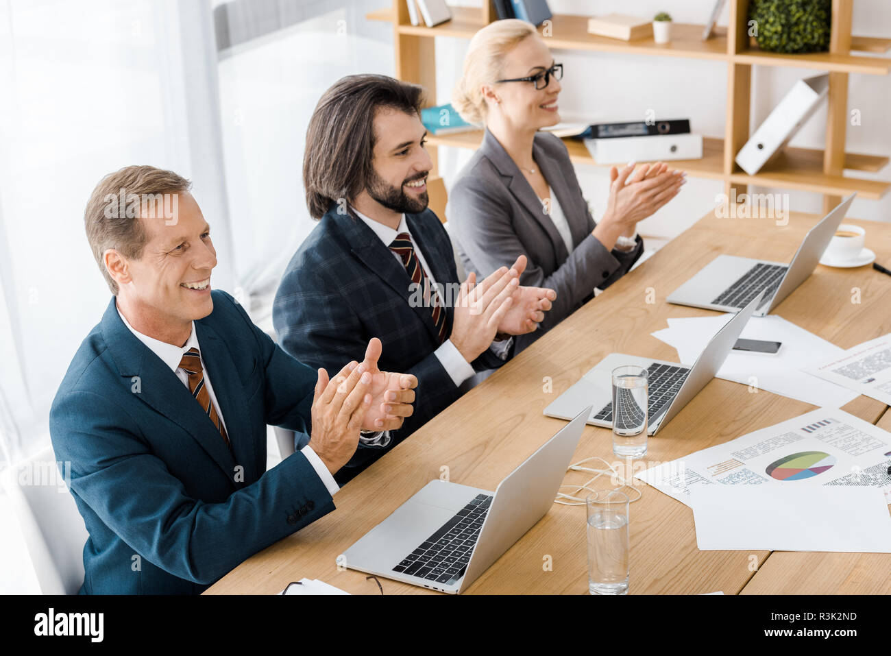 happy business people clapping hands at meeting in office Stock Photo ...