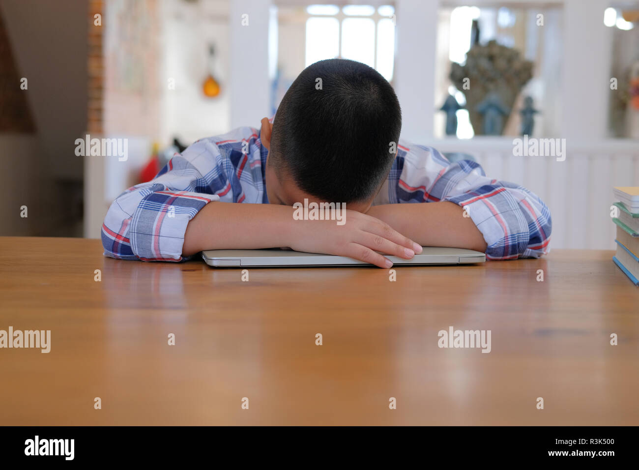 lazy stressed young little asian kid boy resting sleeping on desk ...