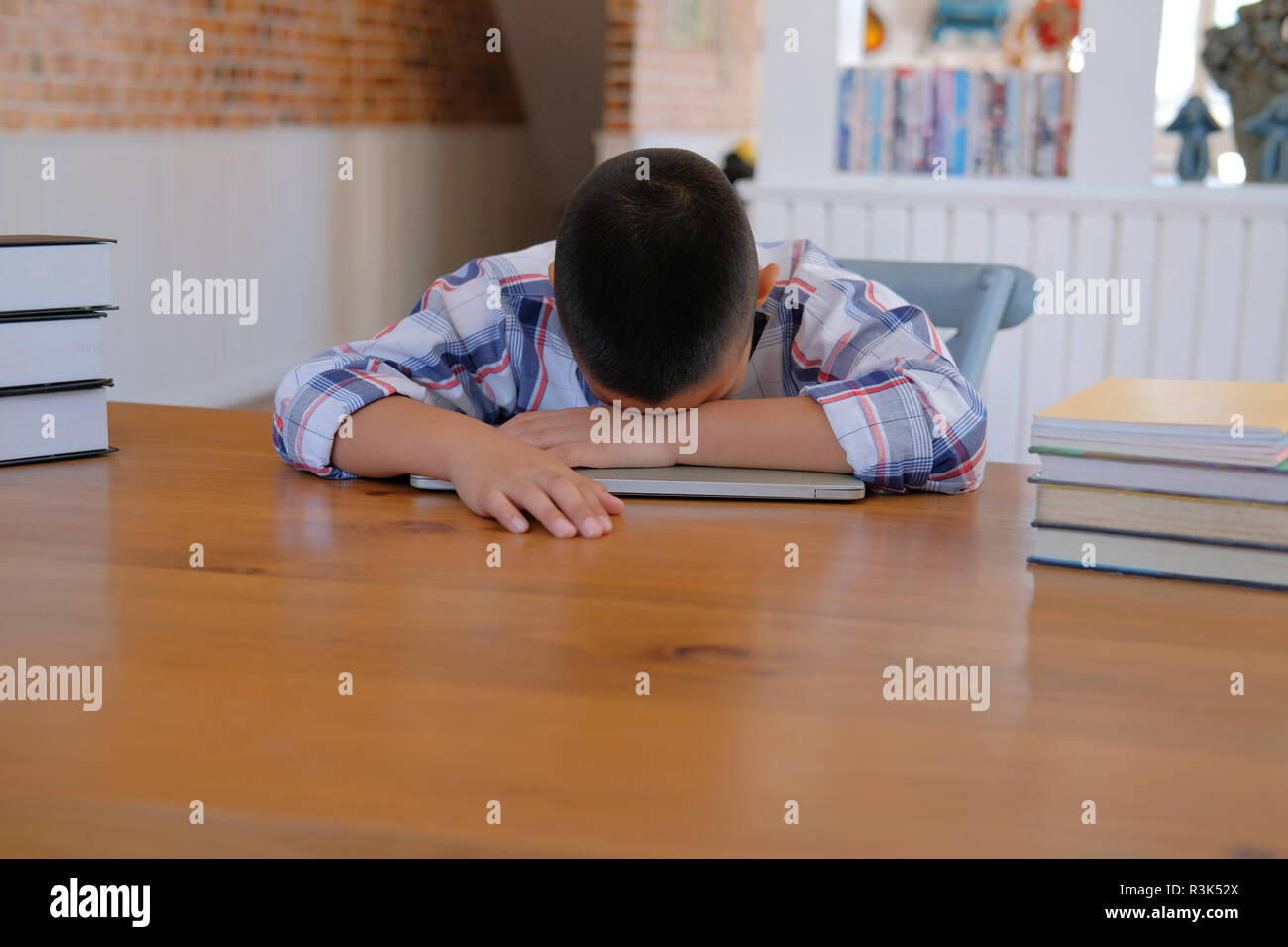 lazy stressed young little asian kid boy resting sleeping on desk ...