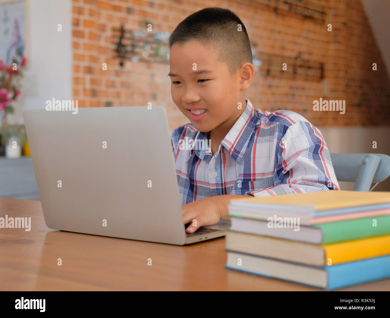young little asian kid boy studying doing homework. child learning ...