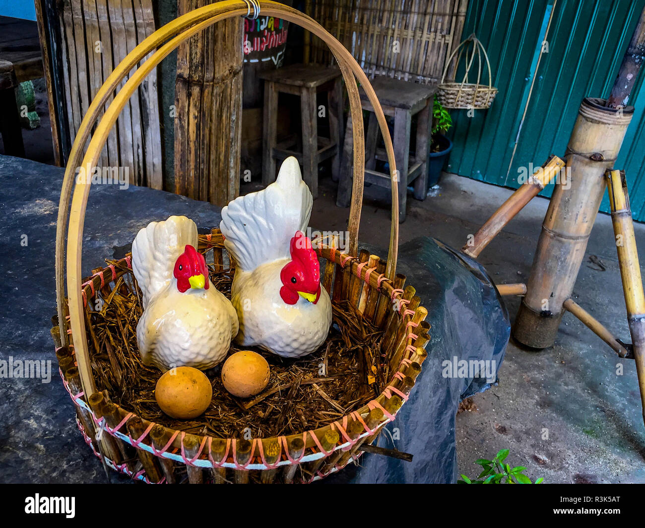 A village in Northern Thailand with a fake Chicken in a basket with ...