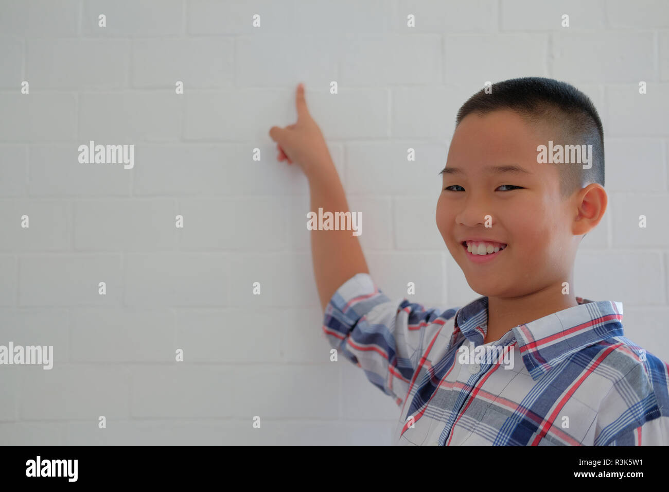 young little asian kid boy child children schoolboy smiling & pointing ...