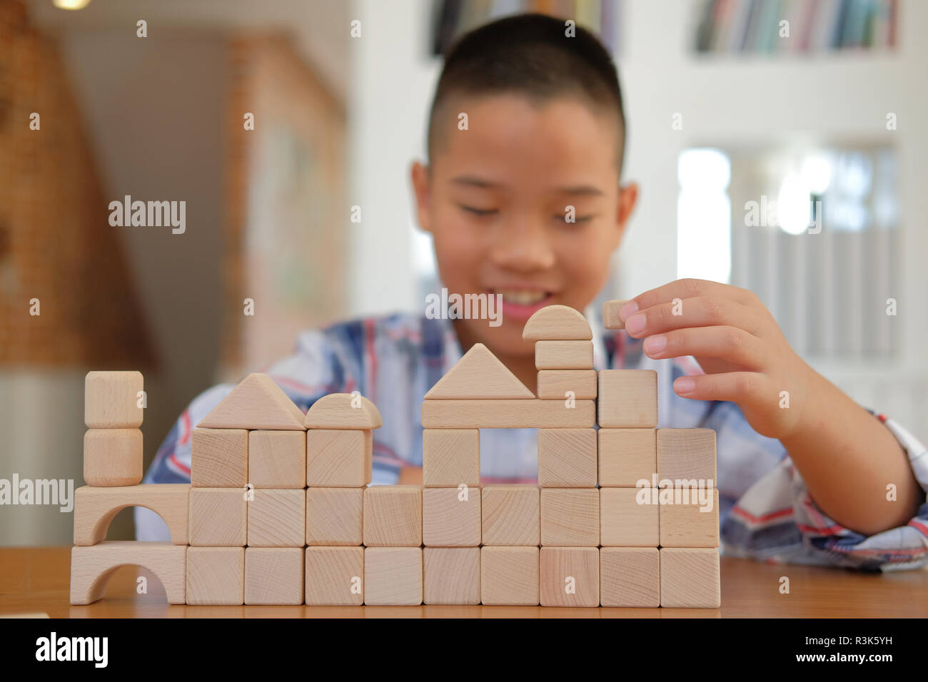 young little asian kid boy child children schoolboy playing wood block ...
