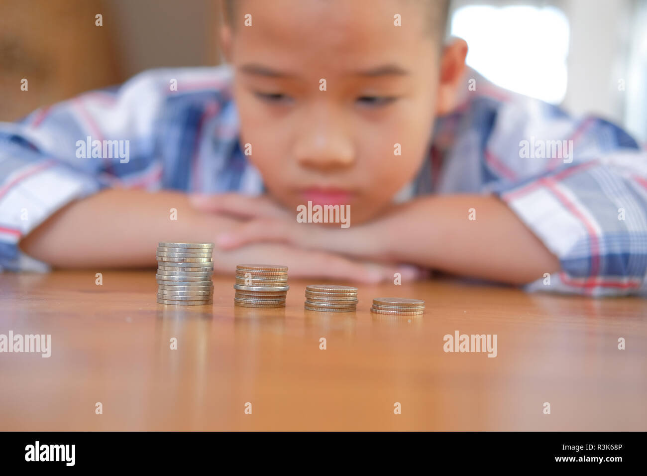 little asian kid boy child children with coins stack pile. money ...