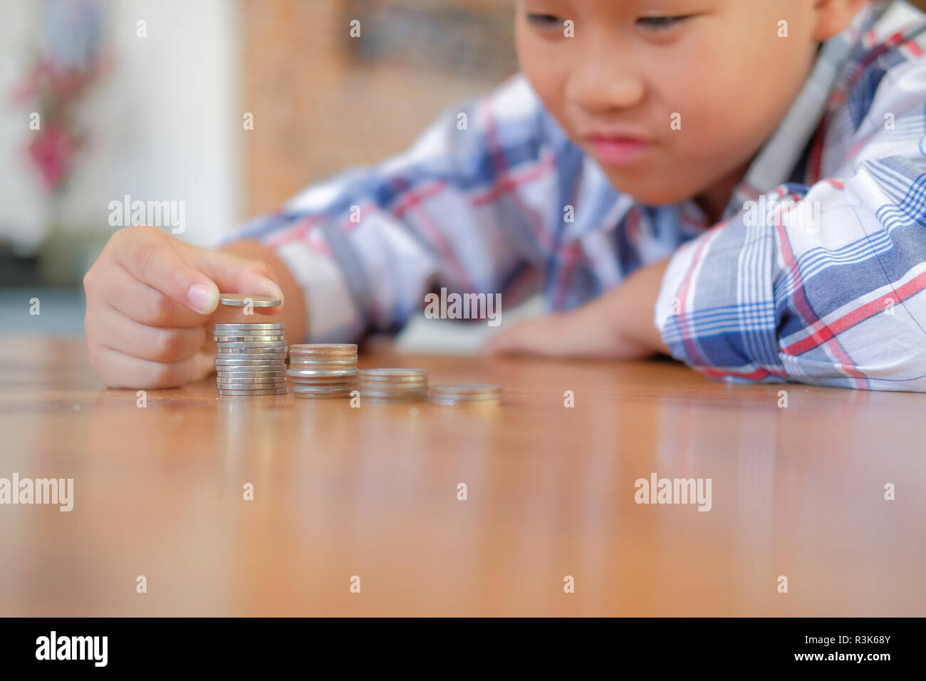little asian kid boy child children with coins stack pile. money ...