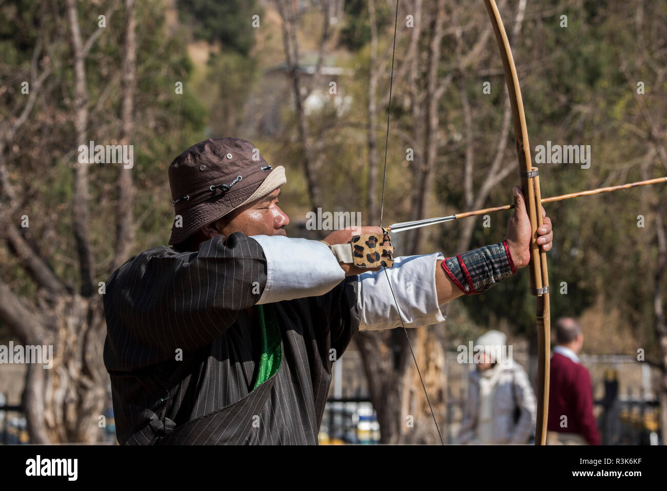 Bhutan, Thimphu, capital of Bhutan. Local archery competition played in ...