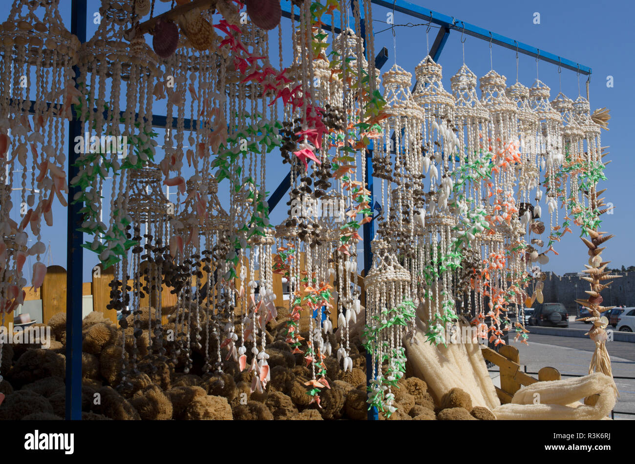 Mediterranean wind chimes made of seashells on the background of blue ...