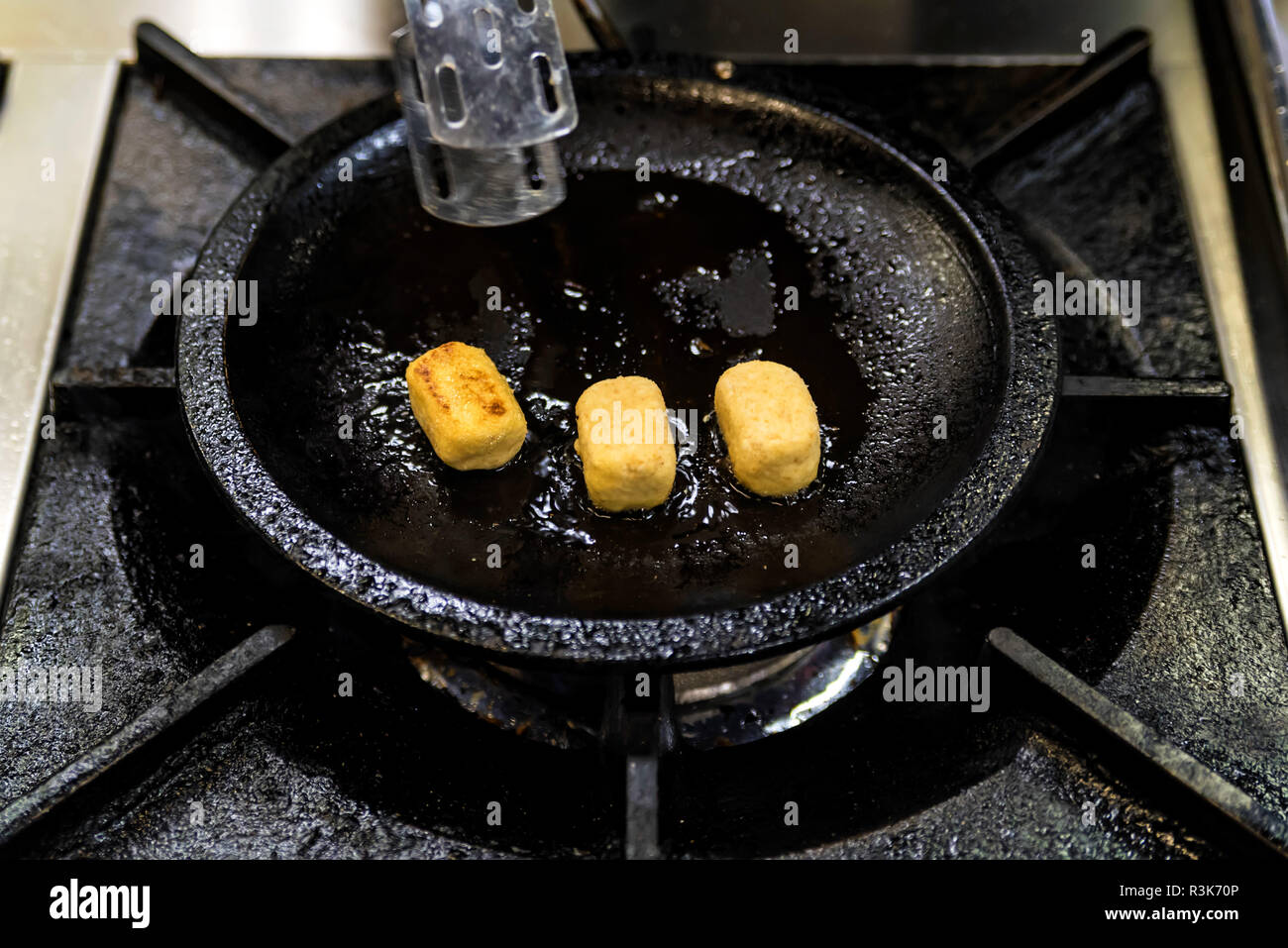 Frying pan with tasty cheese balls close up Stock Photo - Alamy