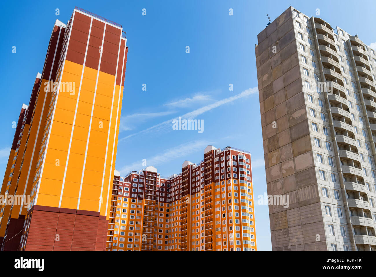 Bright orange high rise residential buildings against blue sky Stock ...