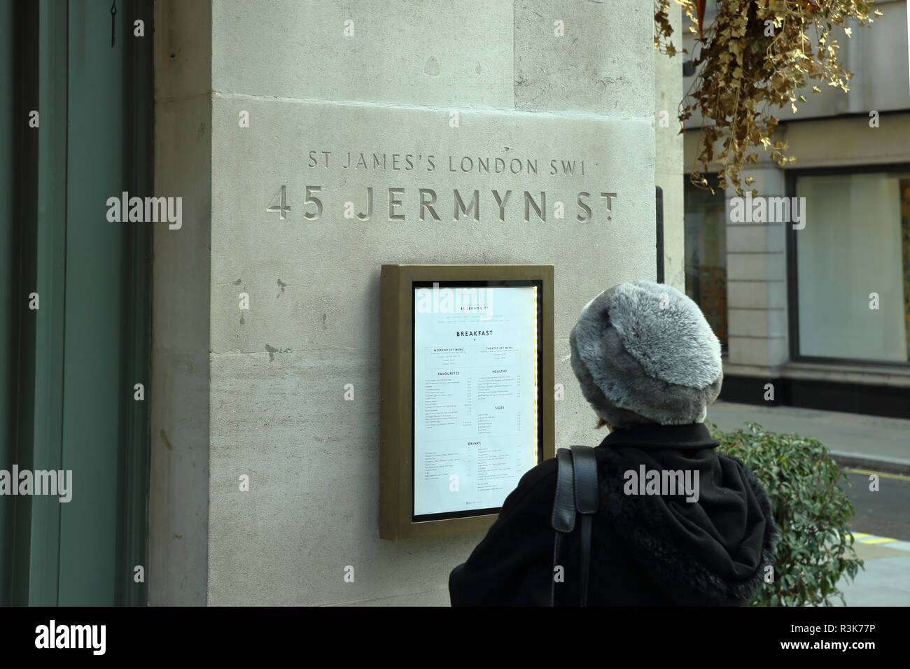 Lady looking at menu outside 45 Jermyn Street, restaurant in London ...