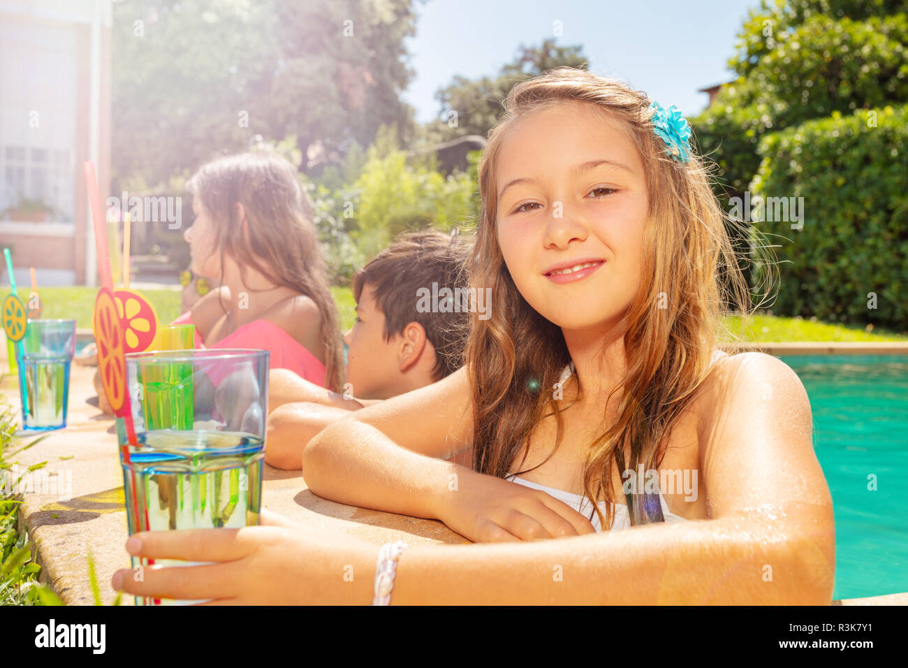 Beautiful girl drinking cocktail in swimming pool Stock Photo - Alamy