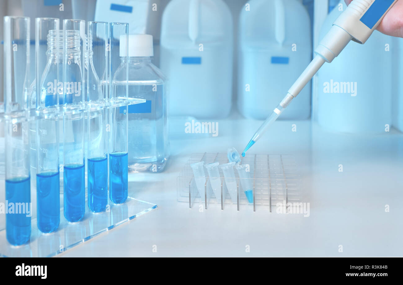 Scientific background in blue and white. Liquid sample loading with ...