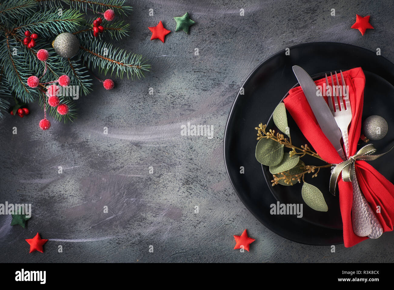 Christmas table setup on dark background with copy-space. Flat lay with ...