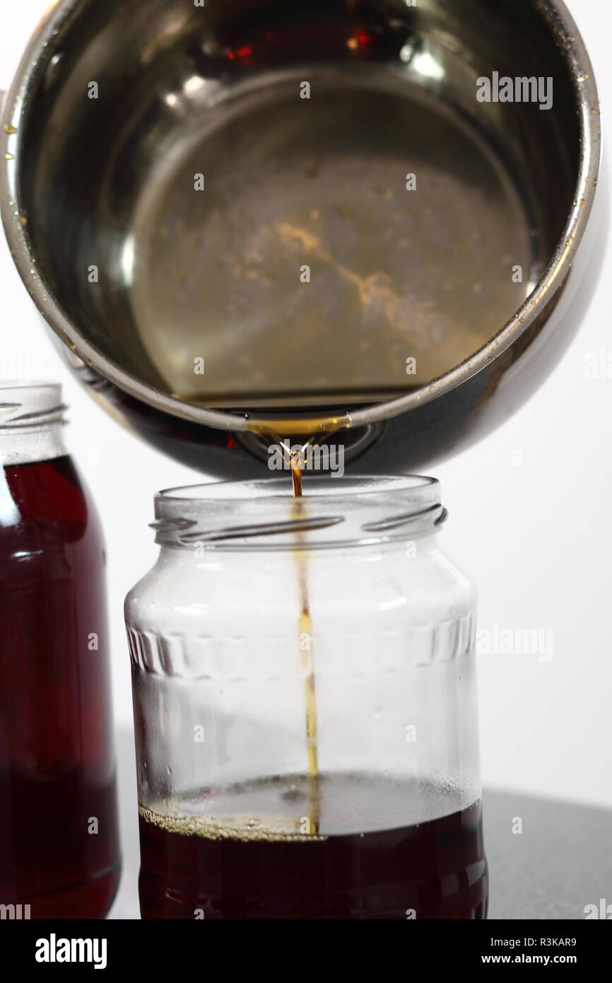 Pouring Black Treacle Syrup into Jars Stock Photo - Alamy