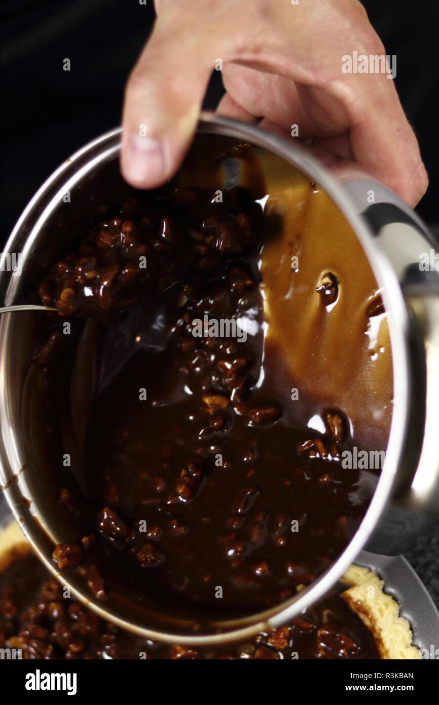 Pouring pecan mixture over top. Making Chocolate, Pear and Pecan Pie ...