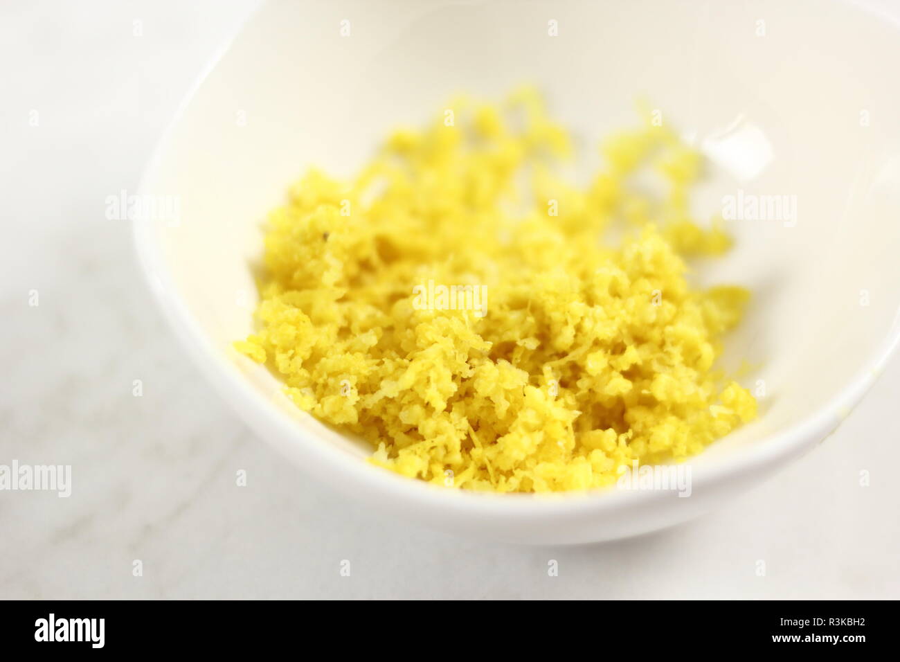 Shredded lemon rind in bowl. Making Lemon Mascarpone Pie Series Stock ...