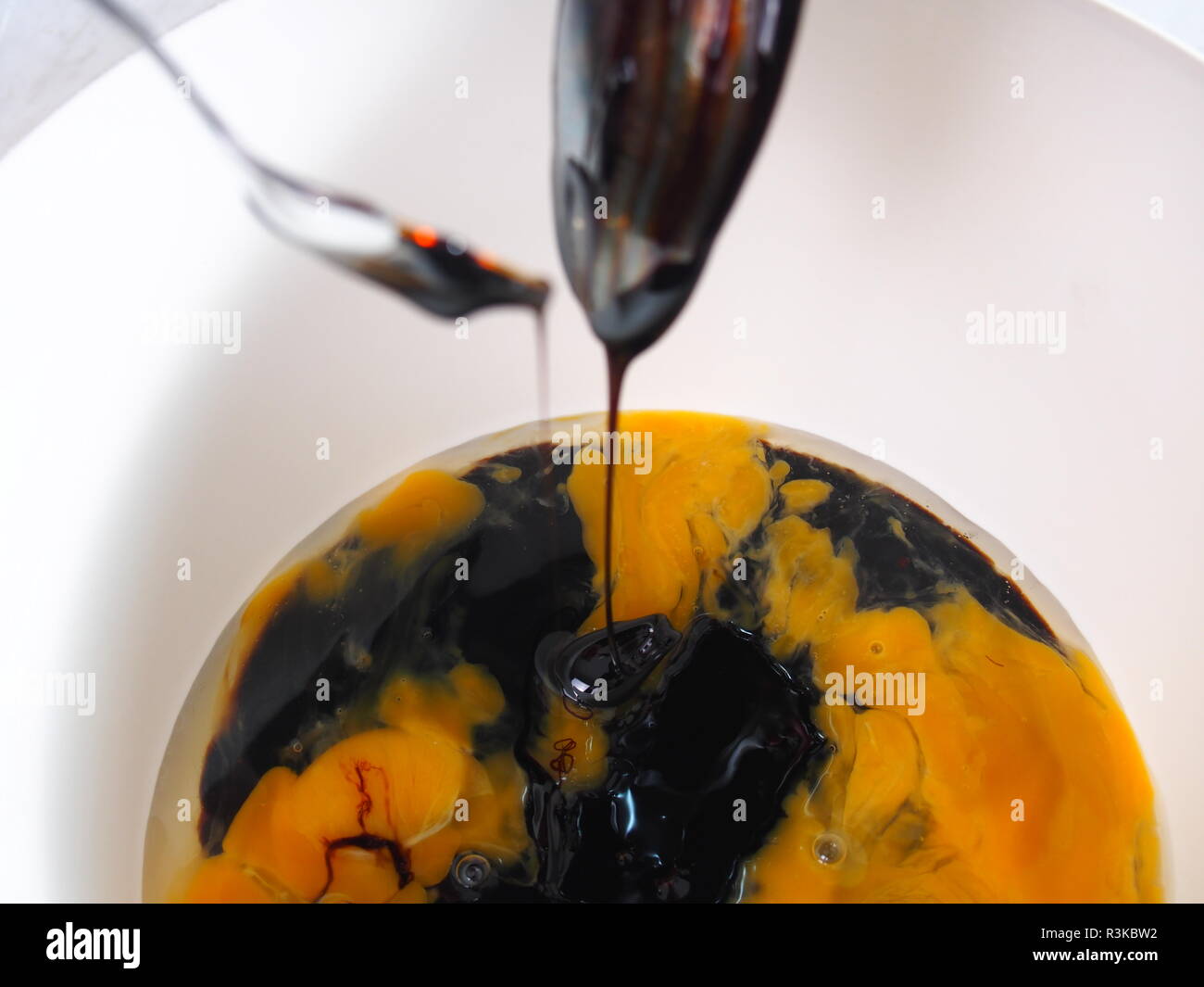 Adding Molasses into Egg Mixture. Making Treacle Pie Series Stock Photo ...