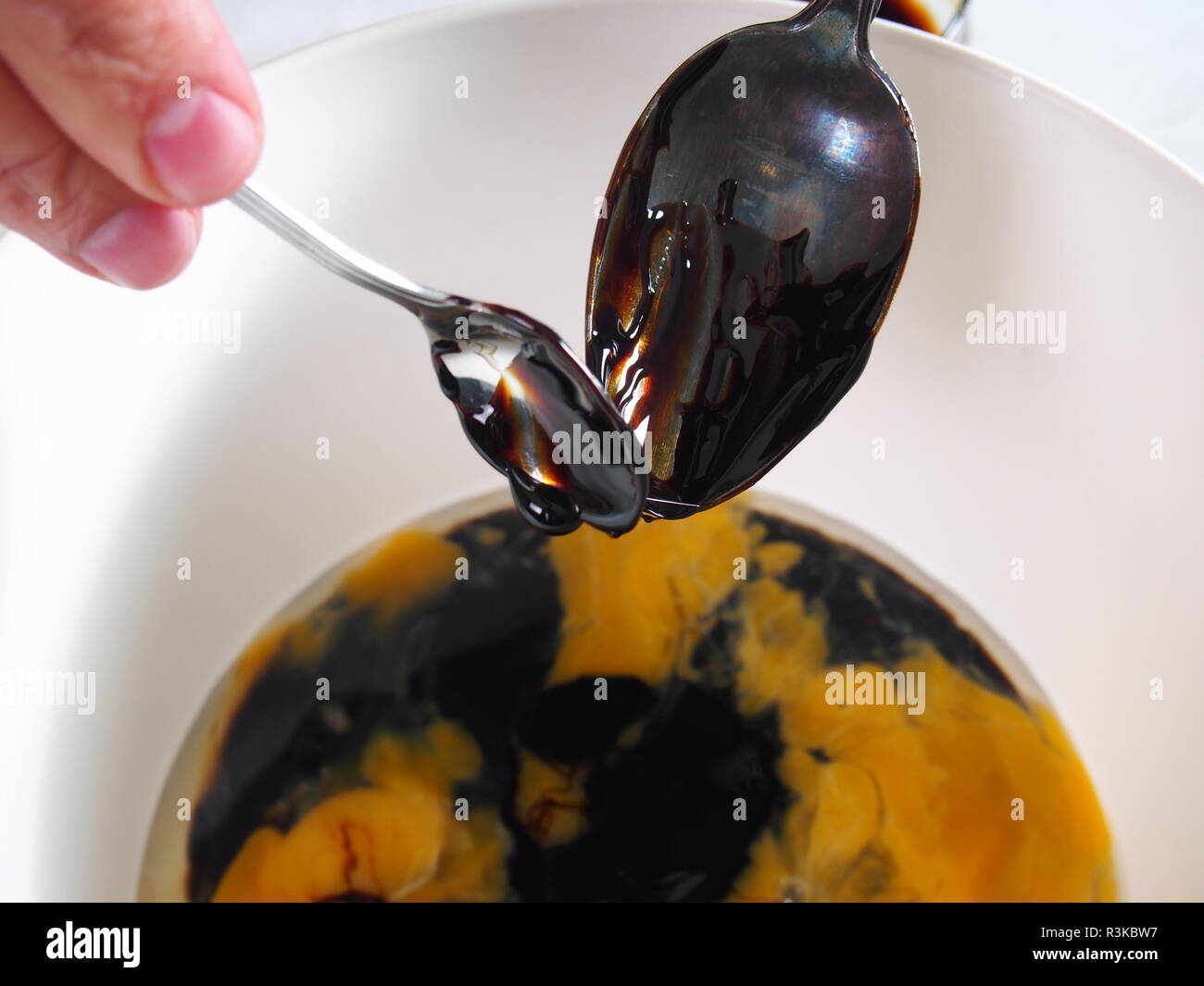 Adding Molasses into Egg Mixture. Making Treacle Pie Series Stock Photo ...