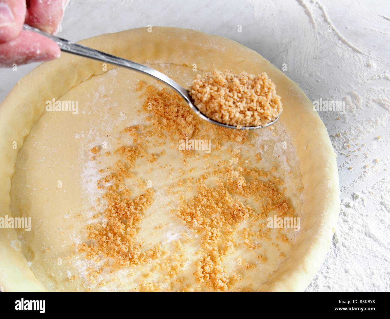 Spoon filling mixture into pastry case. Making Treacle Pie Series Stock ...