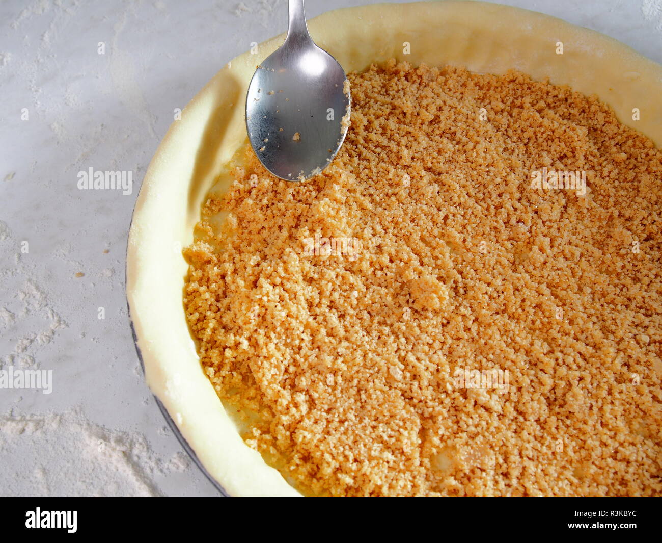 Spoon filling mixture into pastry case. Making Treacle Pie Series Stock ...