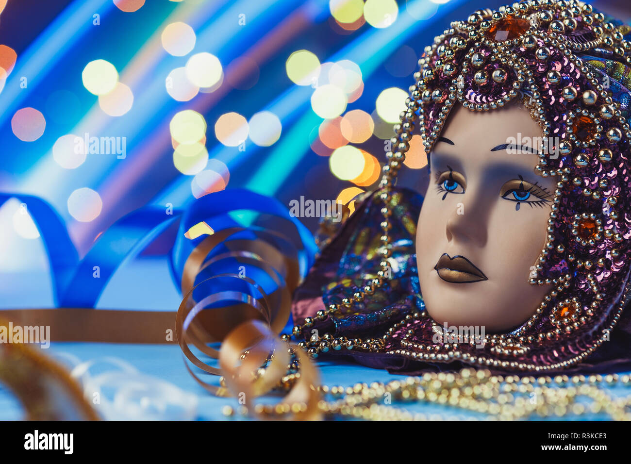 Traditional female carnival venetian mask on blue bokeh background ...