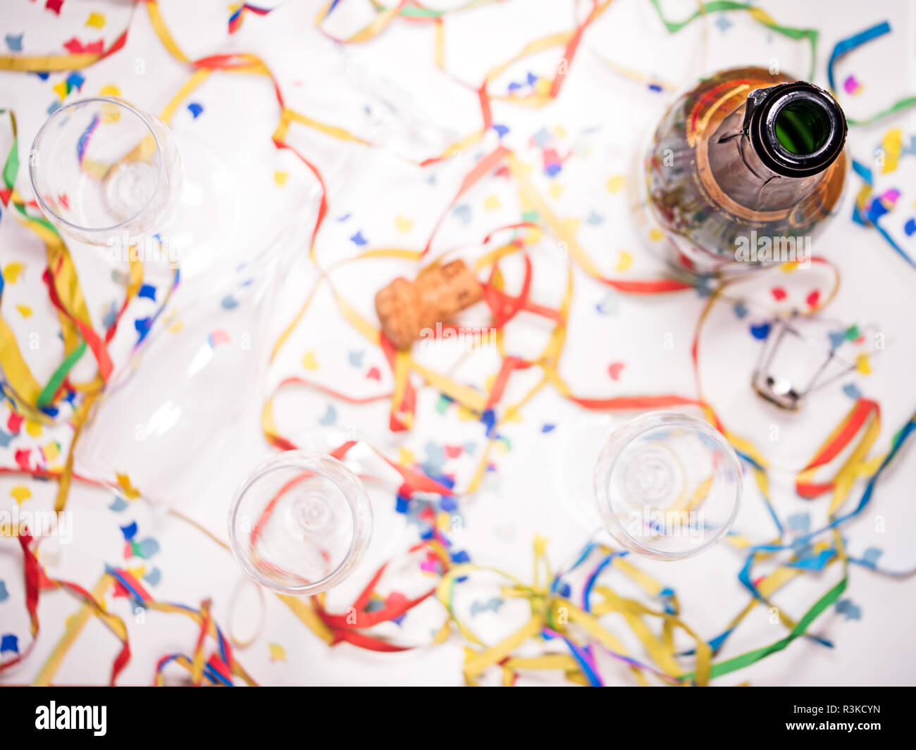 an open bottle of champagne with streamers and confetti Stock Photo - Alamy