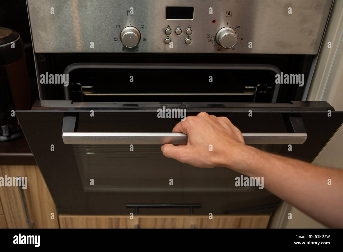 Photo of oven and human hand Stock Photo - Alamy