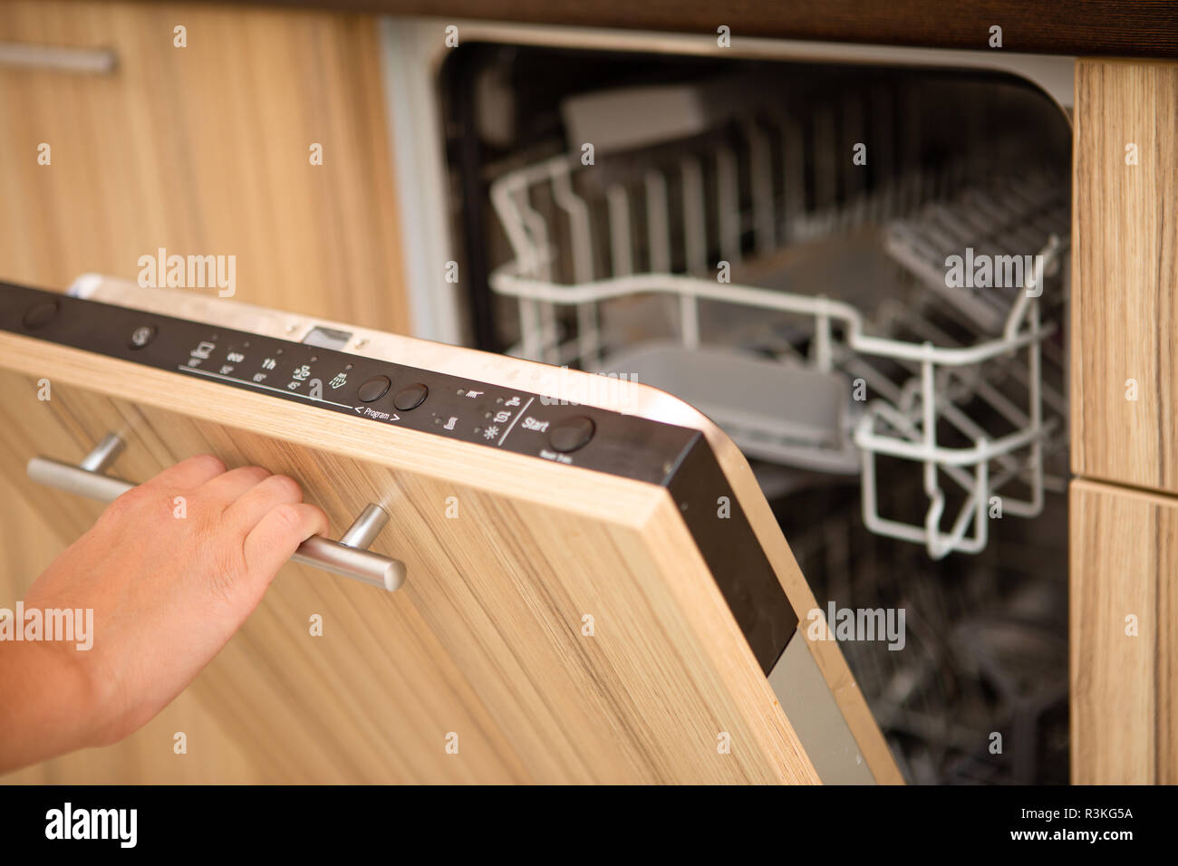 Image of a dishwasher and human hand Stock Photo - Alamy