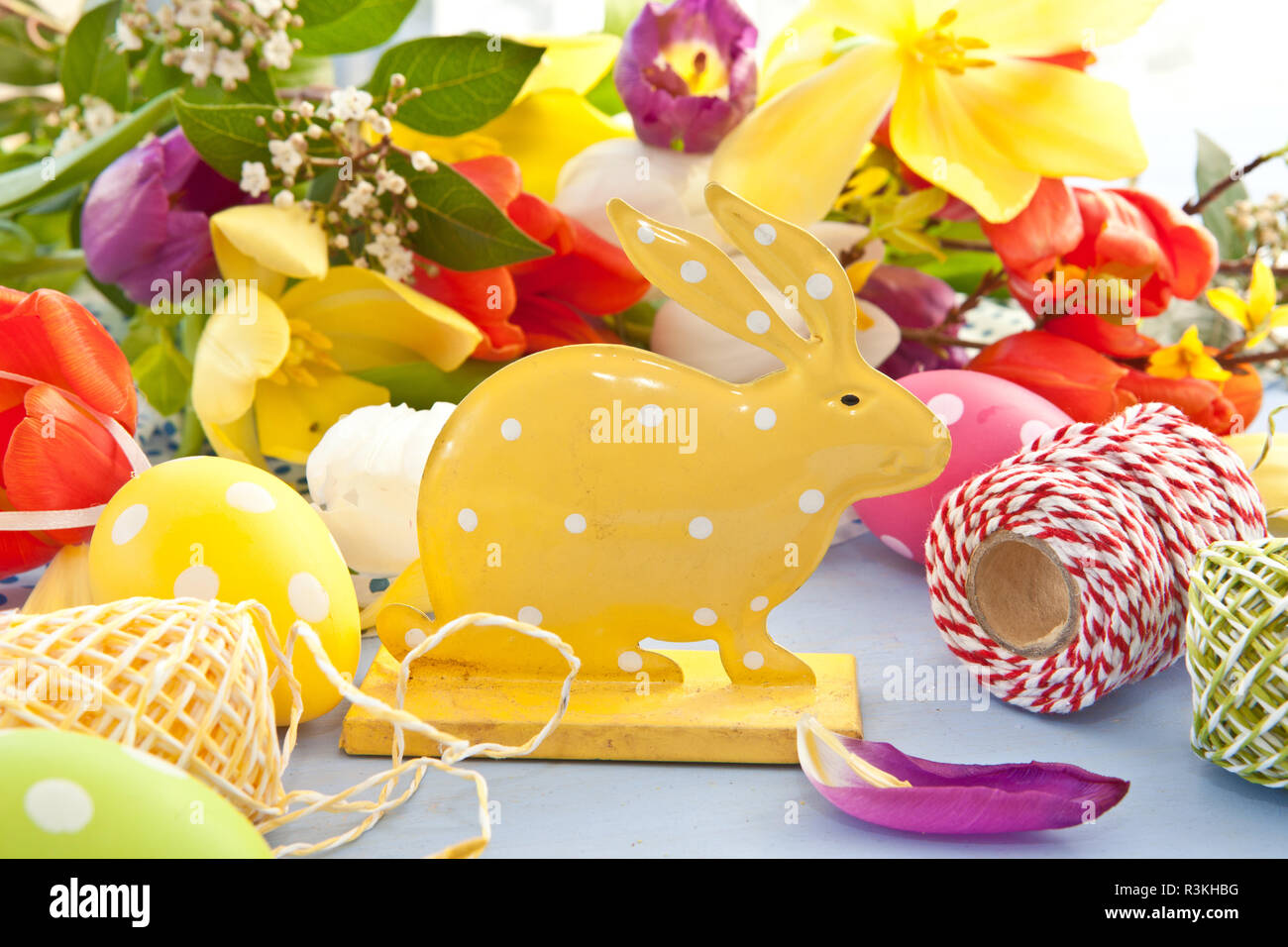 easter bunny in front of colorful flowers Stock Photo - Alamy