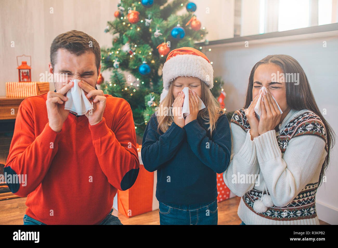 Picture of family suffering from sickness. They blow their noses using ...