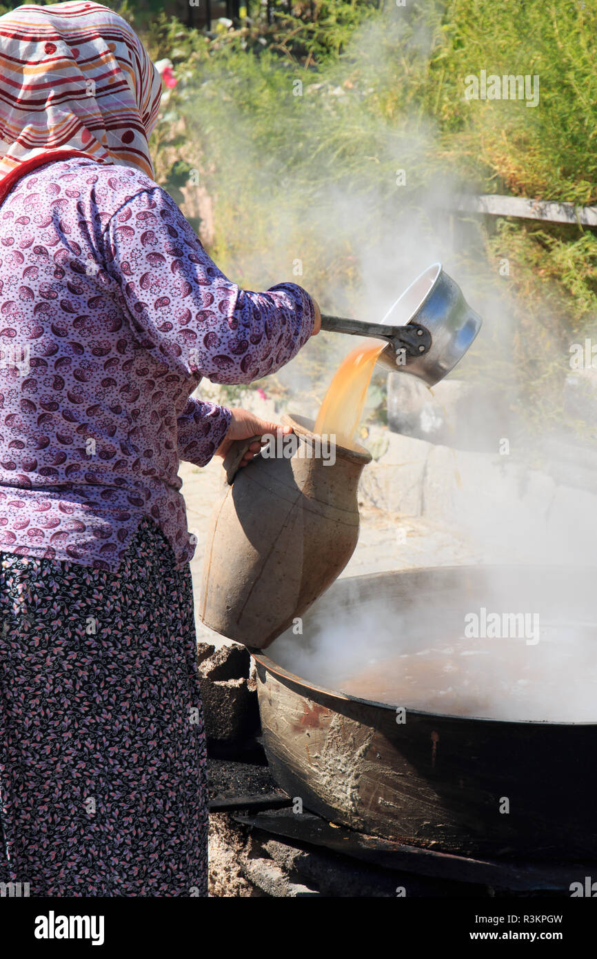Turkey, Cappadocia, Uchisar, woman making Turkish grape molasses (Uzum ...