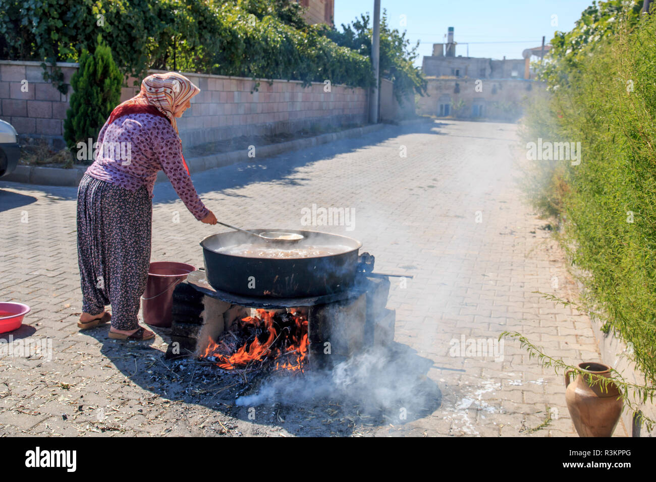 Turkey, Cappadocia, Uchisar, woman making Turkish grape molasses (Uzum ...