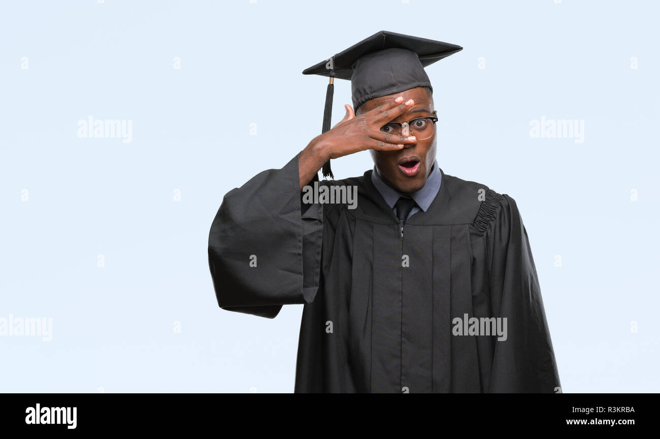 Young graduated african american man over isolated background peeking ...