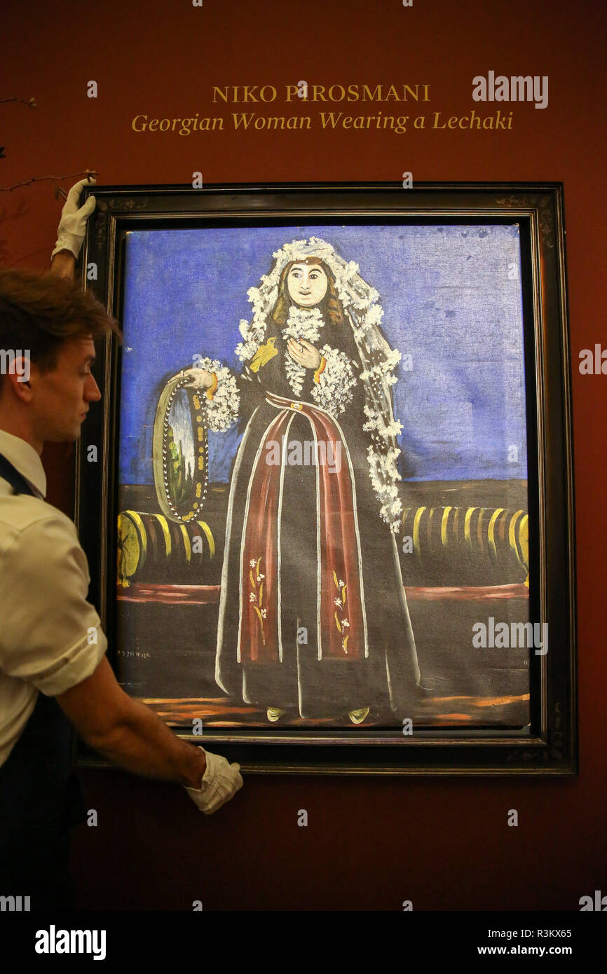Sotheby's, London, UK 23 Nov 2018 - A technician hangs "Georgian Woman ...