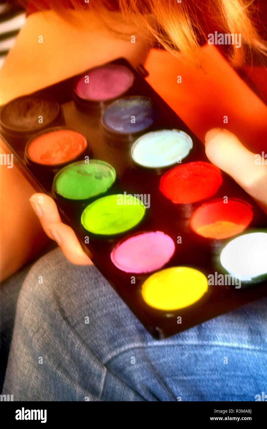 Hand holding water colour palette, in bright and shining colours Stock ...
