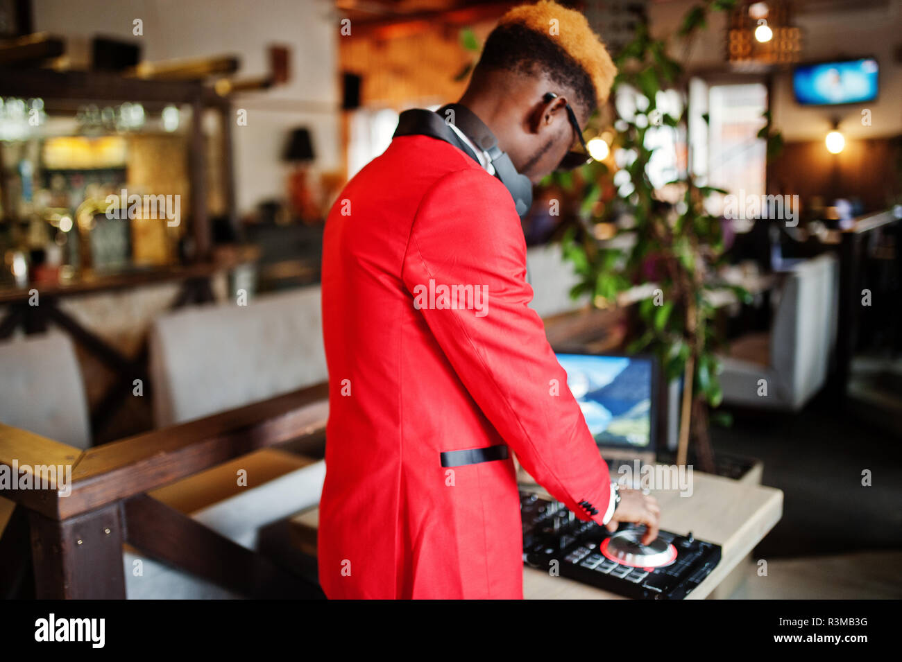 Fashion african american man model DJ at red suit with dj controller ...